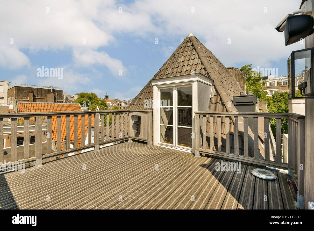 a roof on a house with wood sidings and white trim around the windows ...