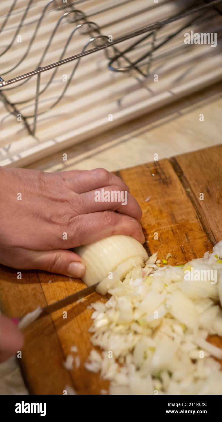 Woman peeling onions cooking hi-res stock photography and images - Alamy
