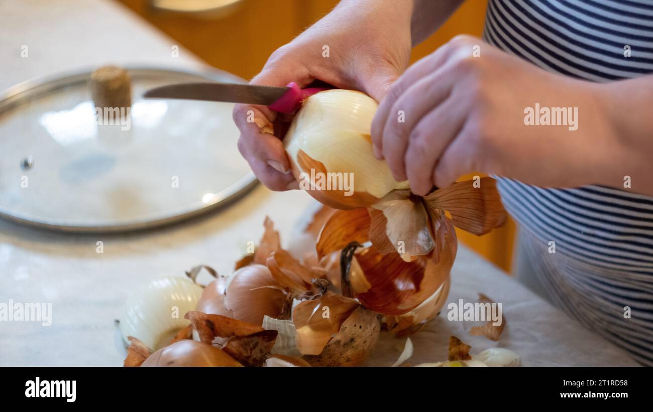 Woman peeling an onion hi-res stock photography and images - Alamy