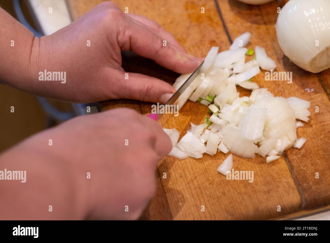 Woman slicing onions in hi-res stock photography and images - Alamy