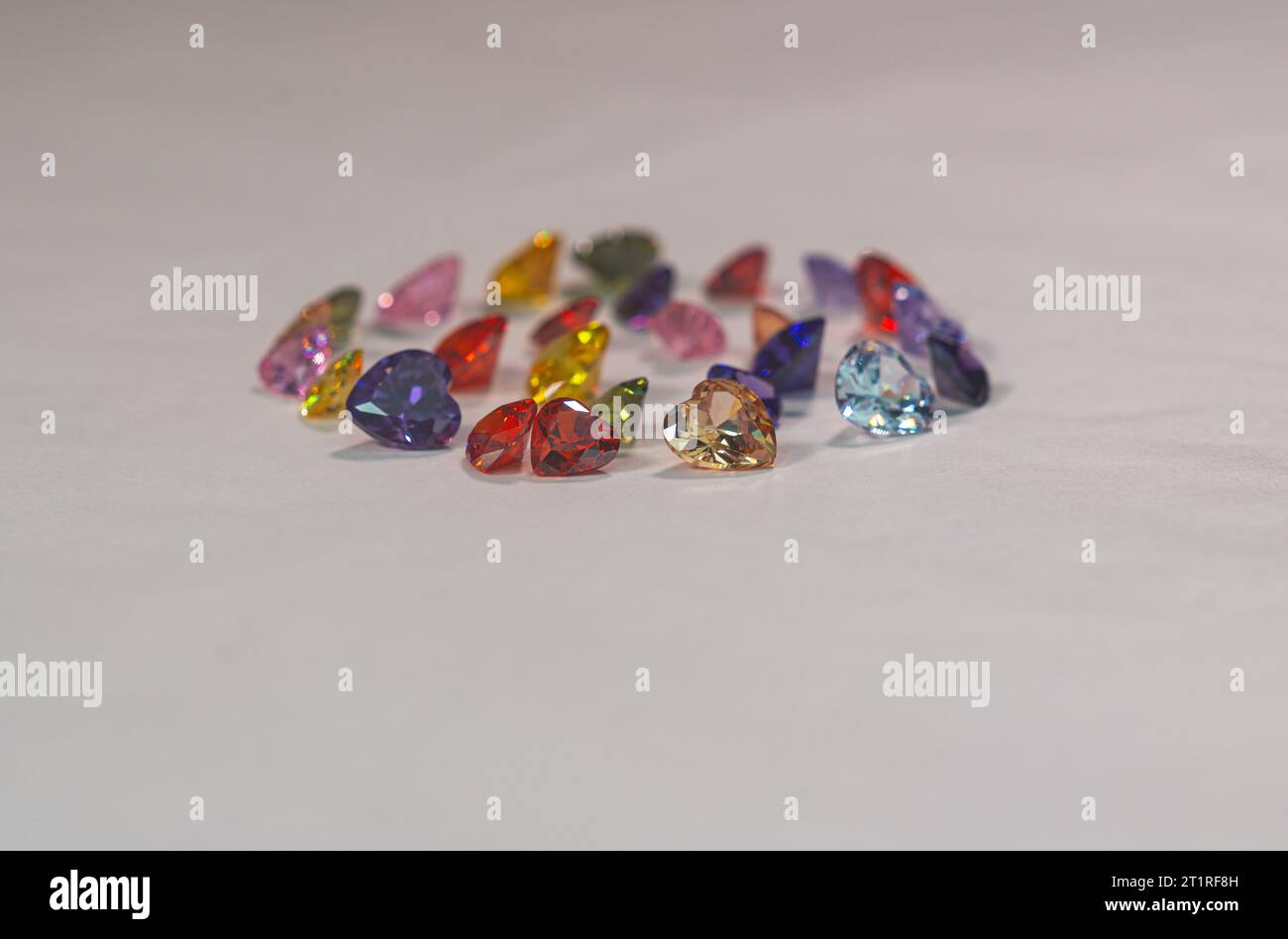 Heart-shaped gemstones in various colors are set in a circle. Natural ...
