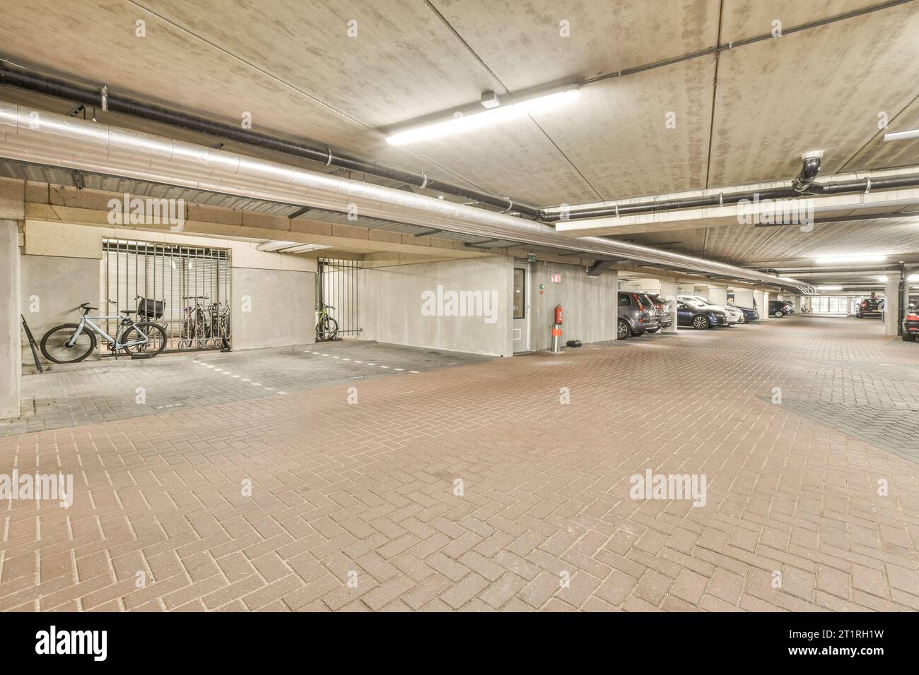 an underground parking area with bikes parked in the garages on either ...