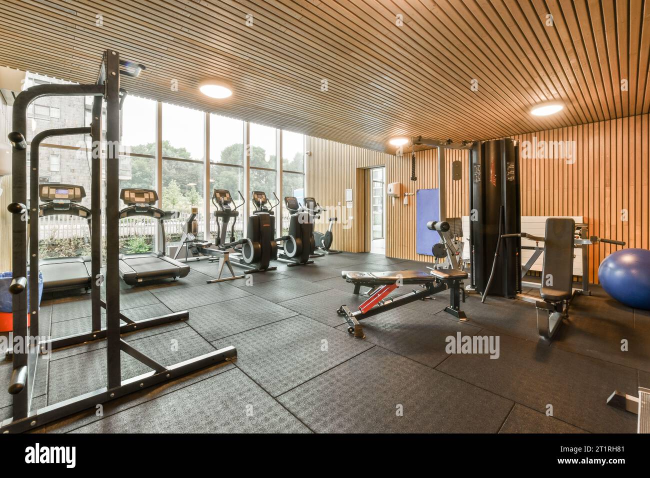 the inside of a home gym with weights, equipment and an exercise mat on ...
