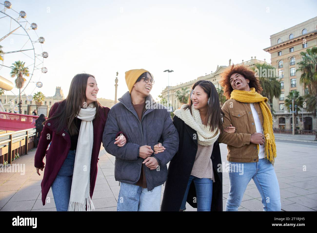 Multiracial Group Laughing Friends Strolling Through Amusement Park