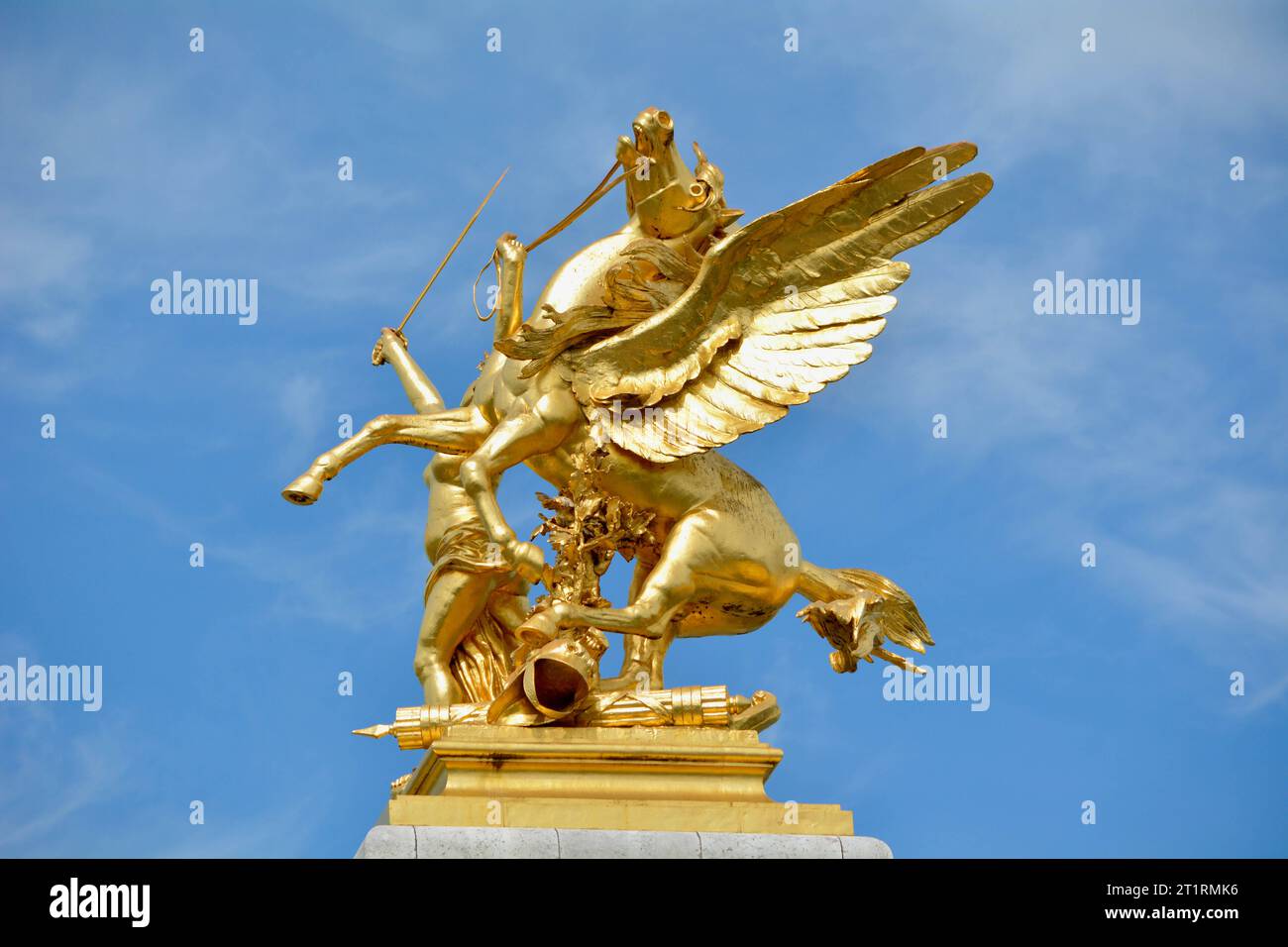 An ornate golden statue of a prancing horse with a soldier holding a ...