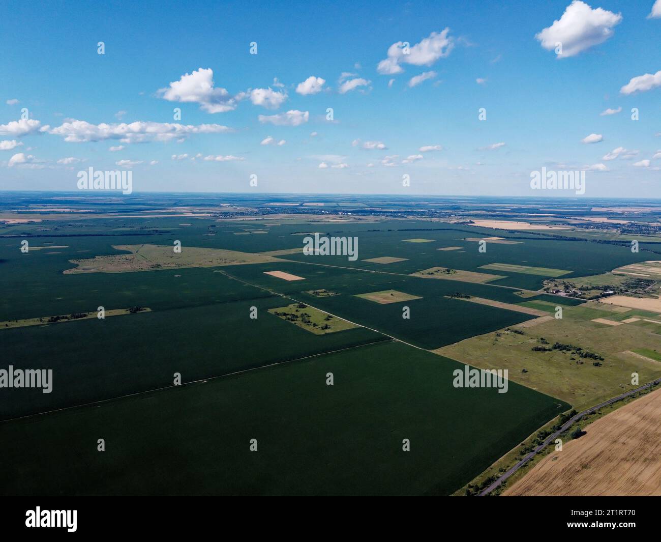 Beautiful agricultural landscape, open field with blue sky and white ...