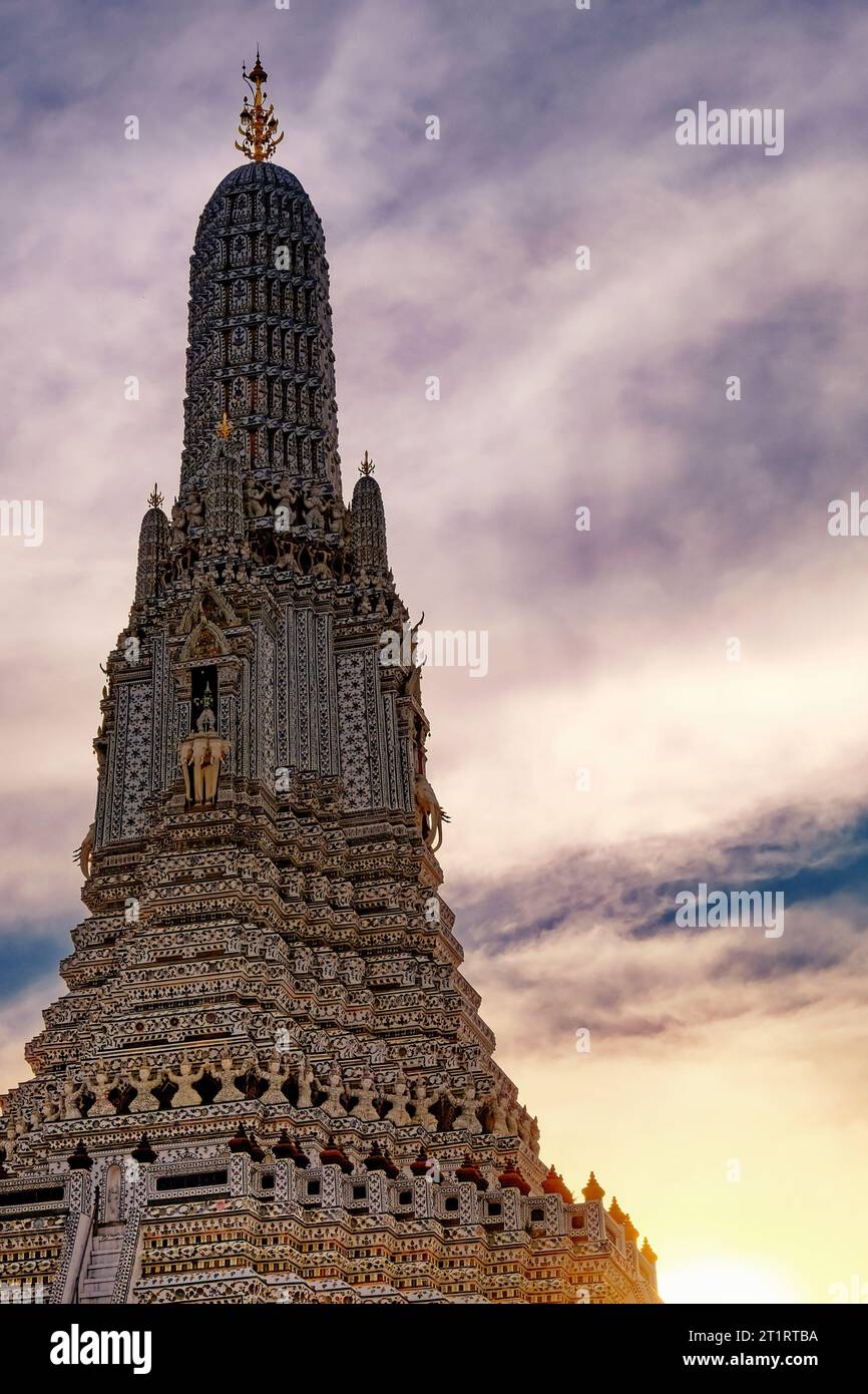 A temple in Thailand. The temple is a tall, ornate structure with many ...