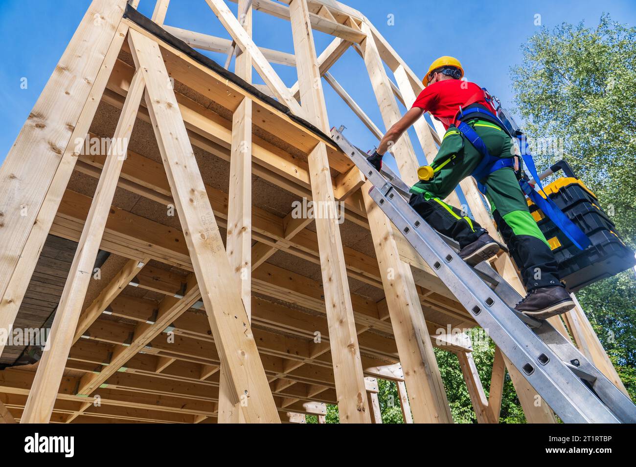 Construction Worker Climbing to Second Level Using Ladder. Wooden House ...