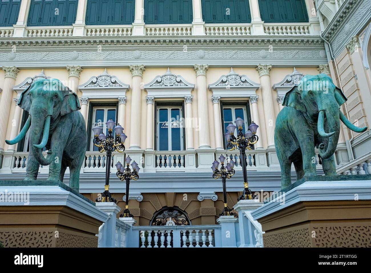 Two life-sized elephant statues on a stone staircase, flanked by lamp ...