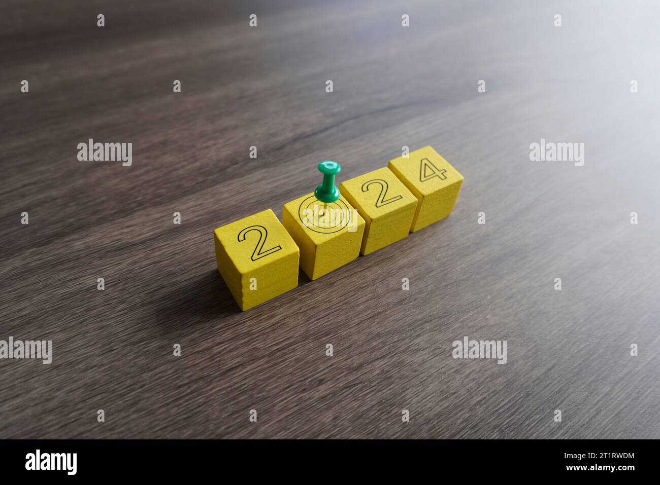 Close-up of a green pin on top of yellow blocks with number 2024. New ...