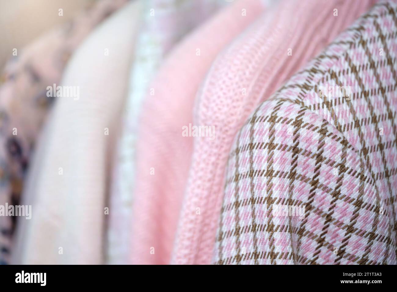 Fashion clothes on clothing rack Closeup of rainbow color choice female ...