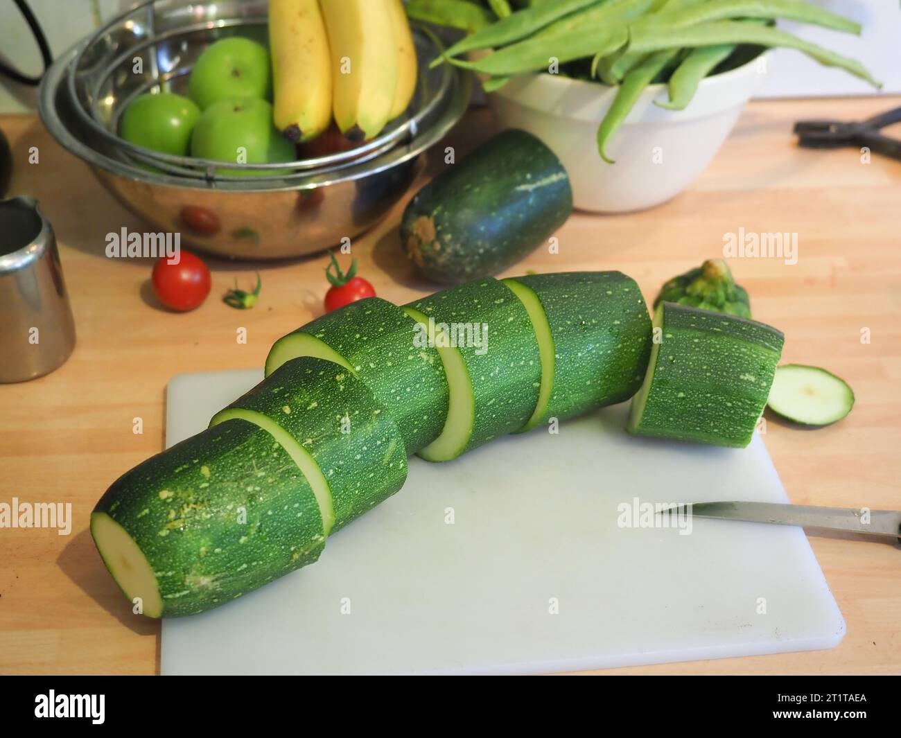 A large courgette chopped into sections on kitchen work surface Stock ...