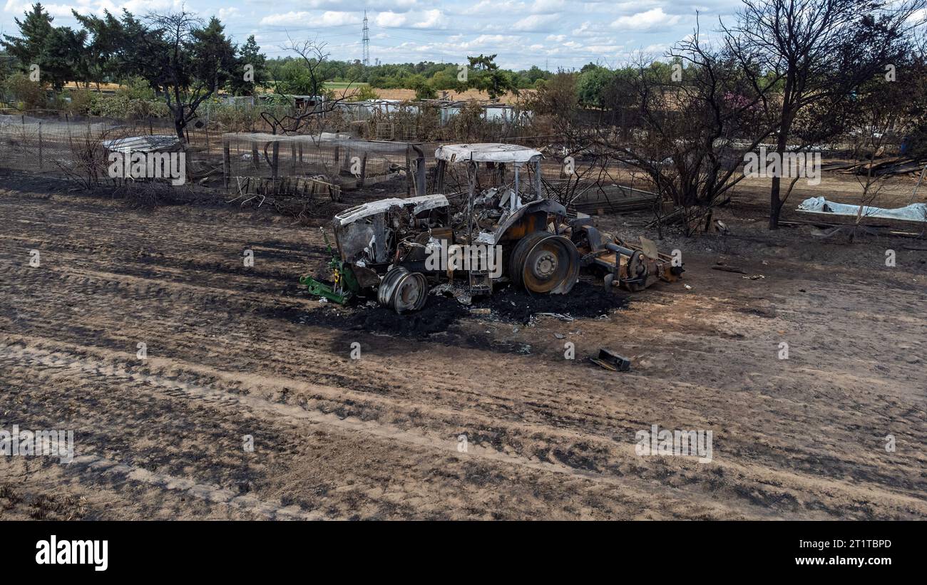 Wildfire on a grain field with a burned tractor in Weiterstadt in the ...