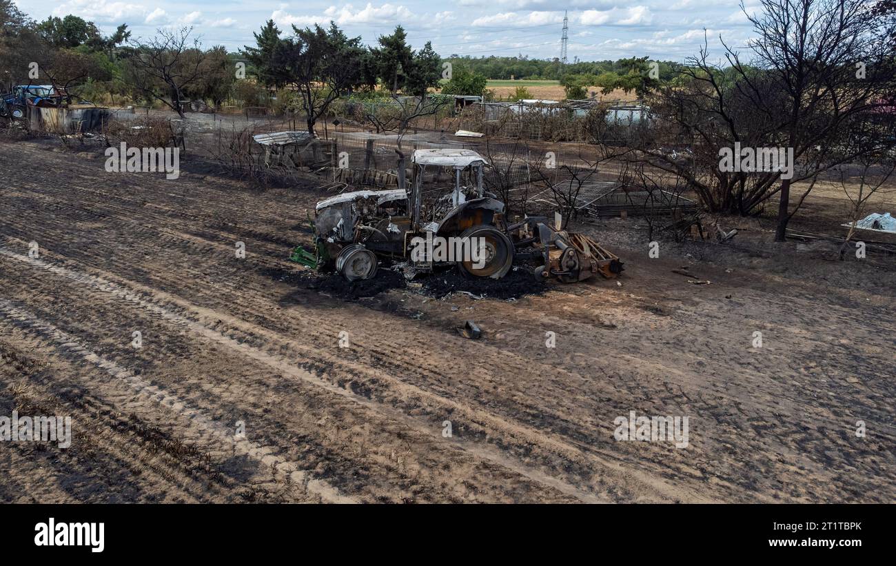 Wildfire on a grain field with a burned tractor in Weiterstadt in the ...