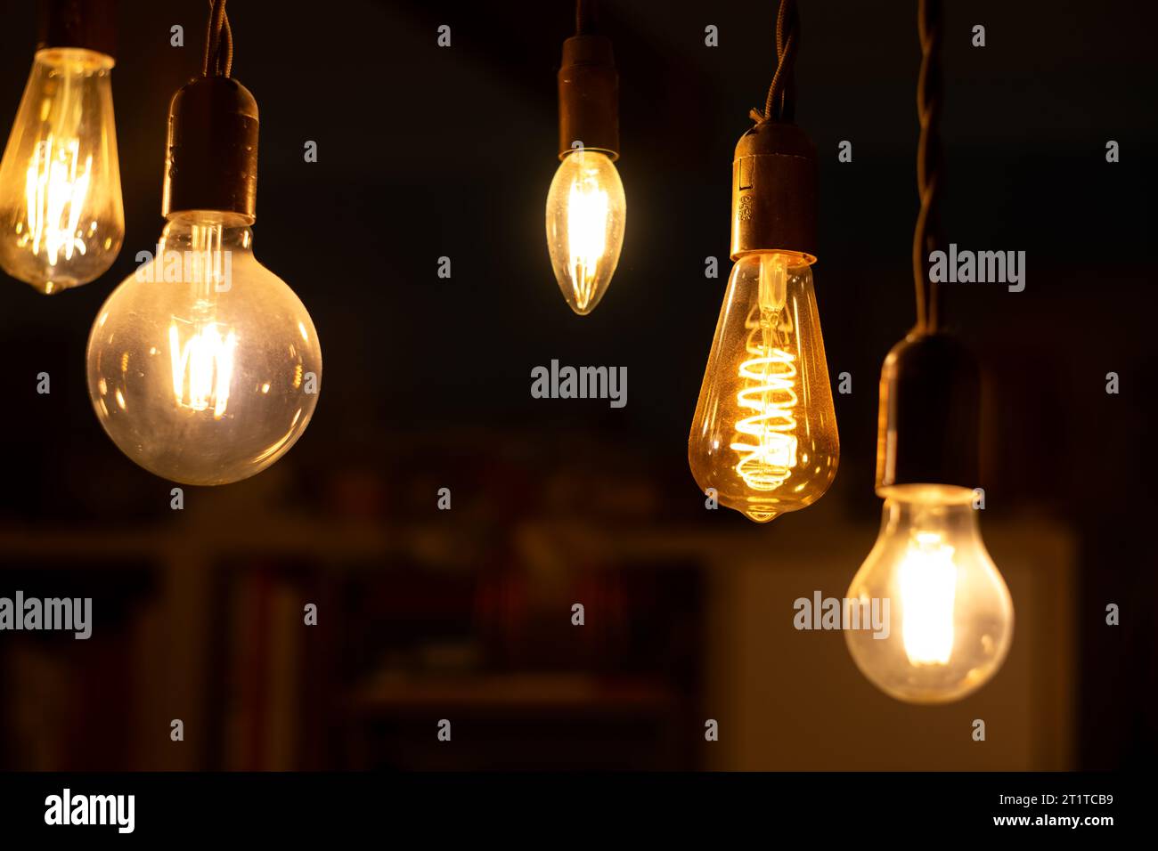 Retro LED light bulbs hanging on a dark background in interior ...