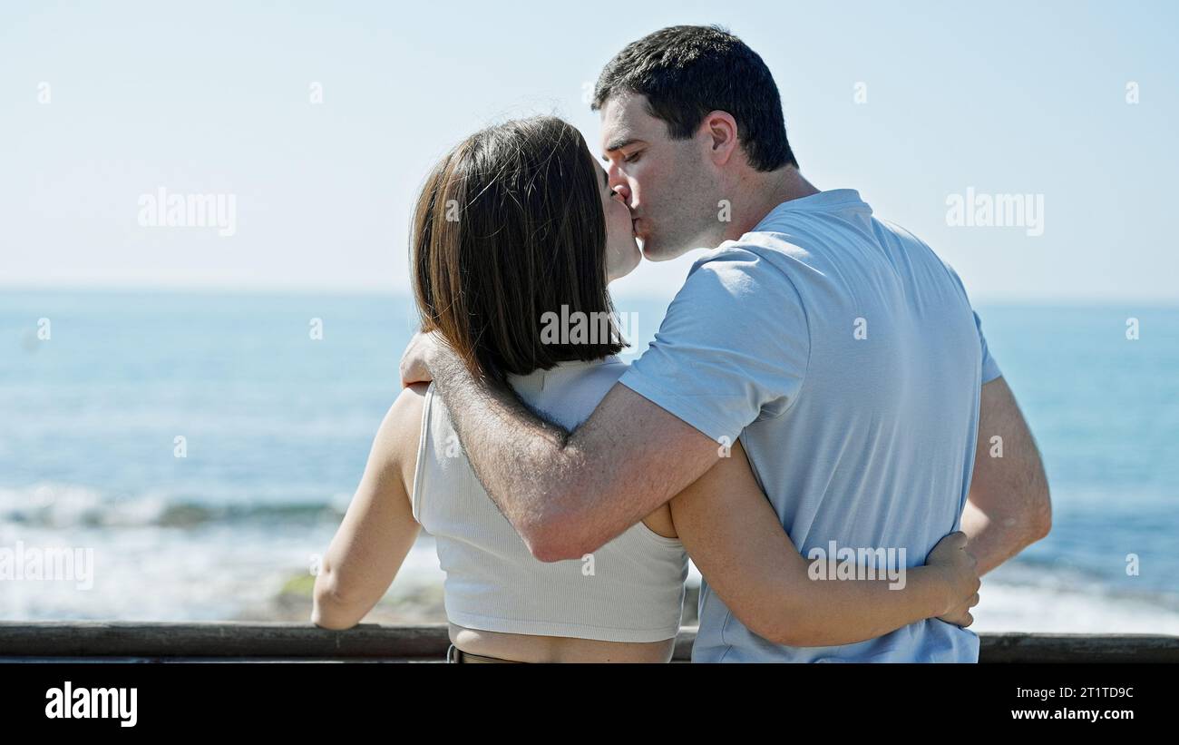 Beautiful couple hugging each other standing backwards kissing at ...