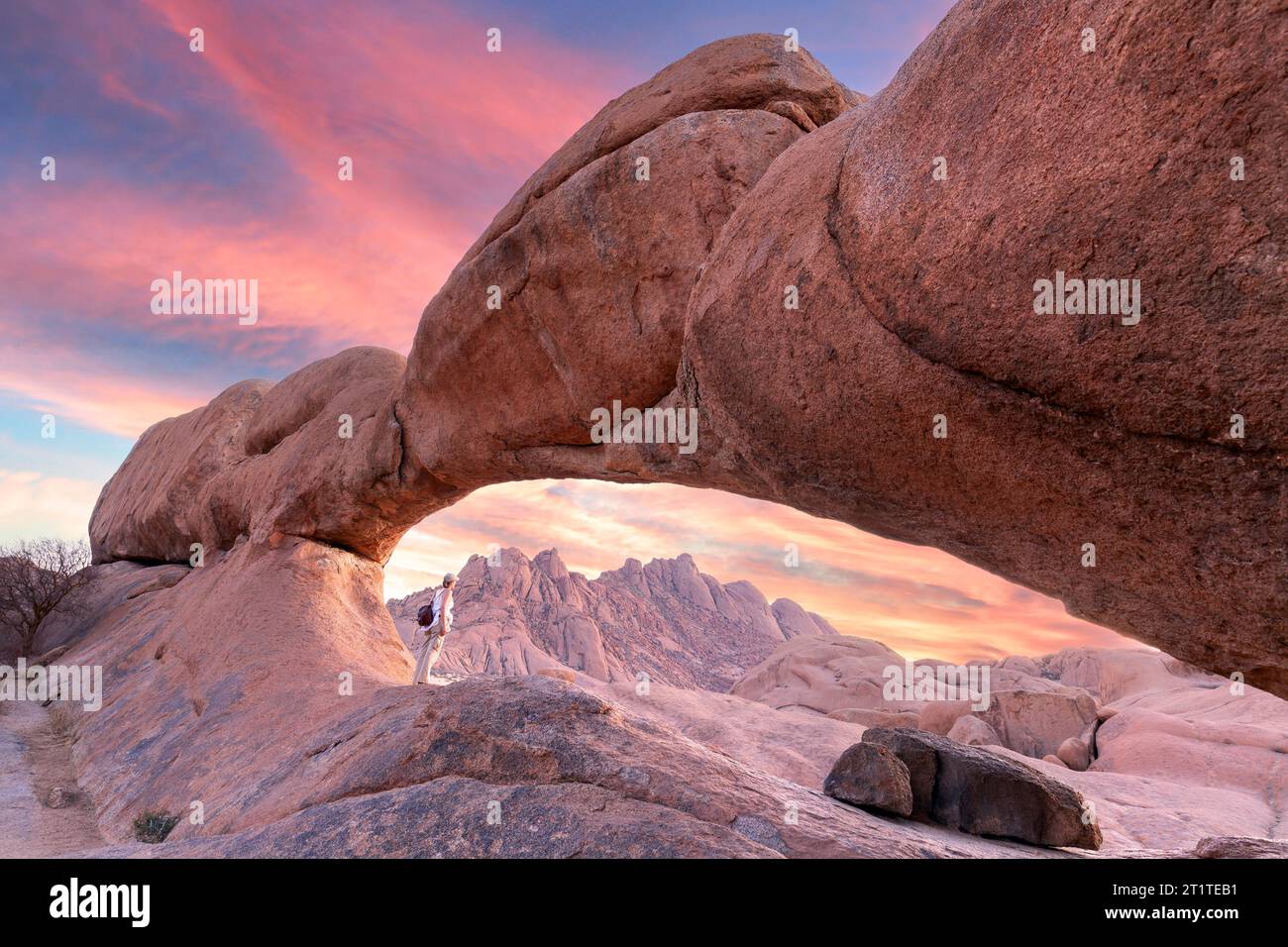 Young girl in Spitzkoppe area with picturesque stone arches and unique ...