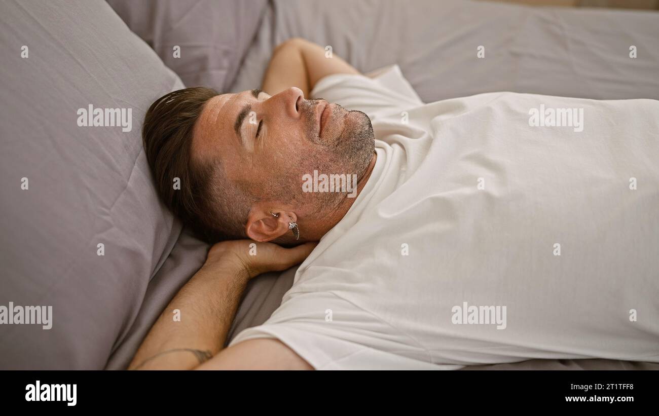 Captivating portrait of a handsome young hispanic man exhausted, deep ...