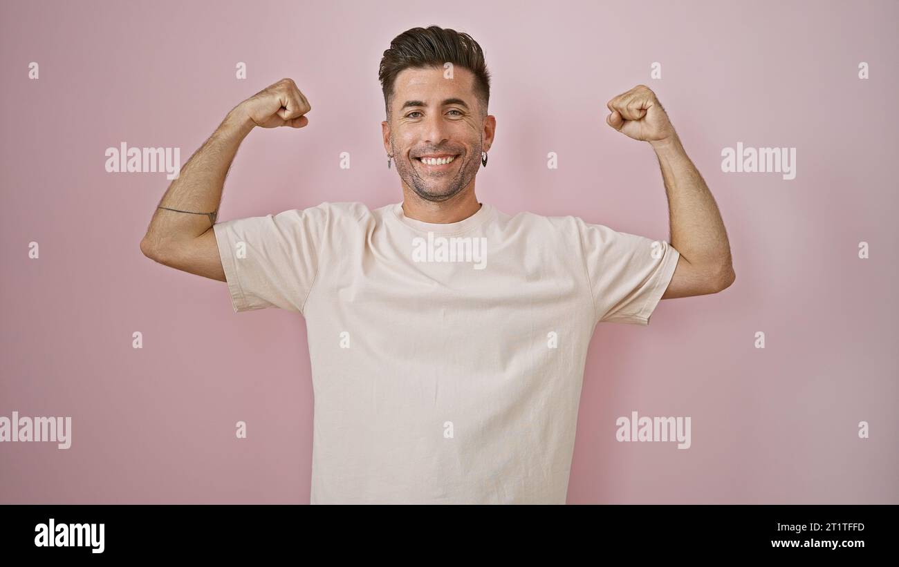 Radiant young hispanic man exudes confidence, his arms gesturing strong ...