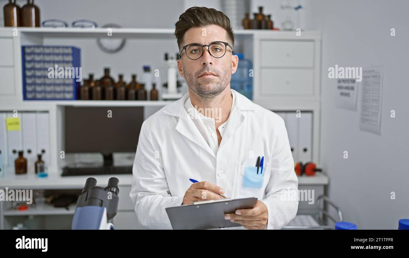 Handsome young hispanic man, charismatic scientist engrossed working ...