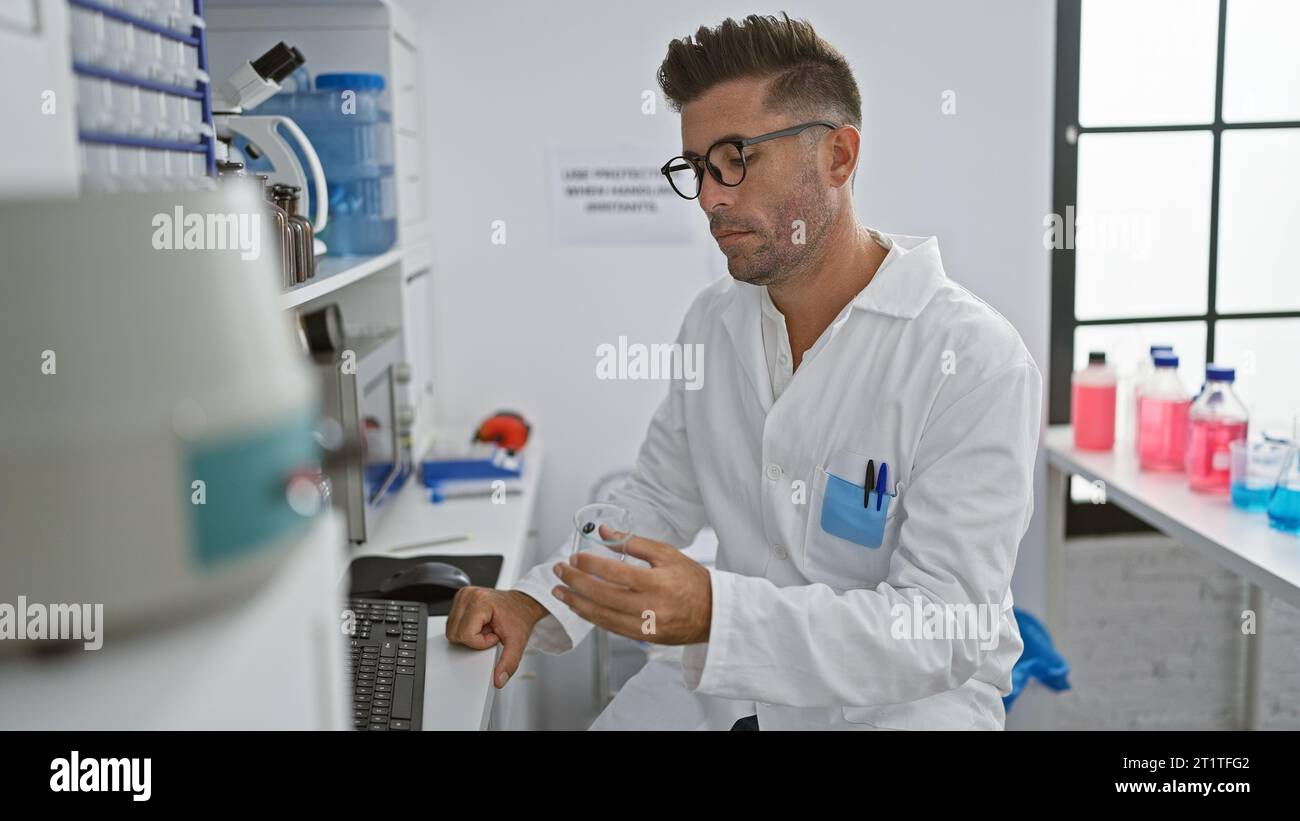 Attractive young hispanic man, working tirelessly in the lab, engrossed ...