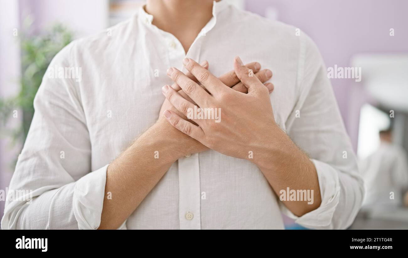 Grateful man, hands on chest, expressing a peaceful mind, trust and ...