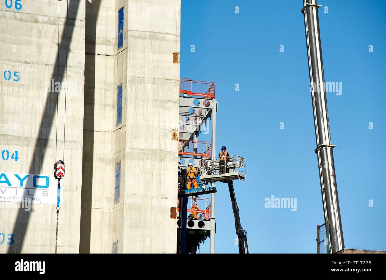 Three men working at altitude on new office block construction Stock ...