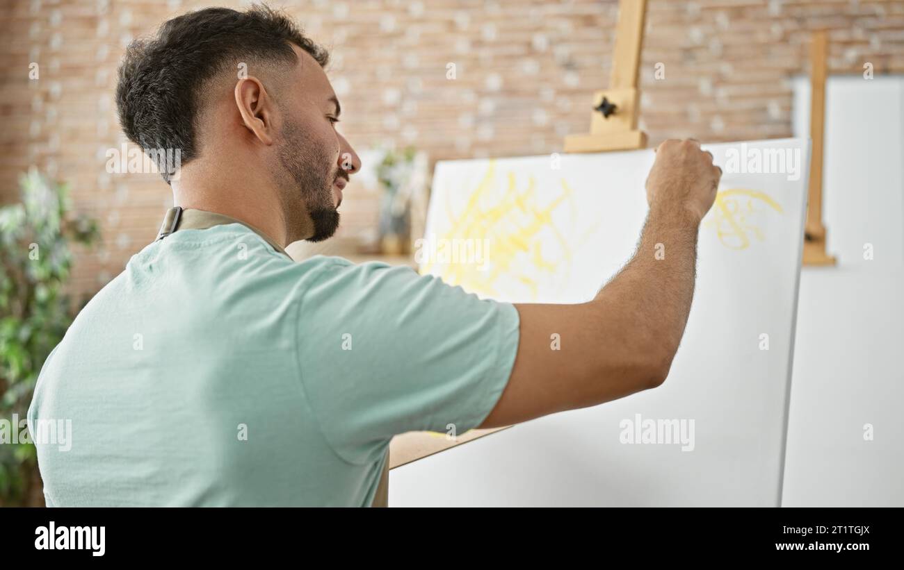 Young arab man artist drawing with serious face at art studio Stock ...