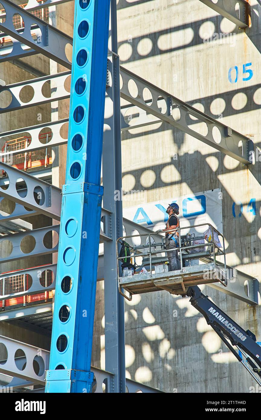 Construction worker on a platform at height working on the steel ...