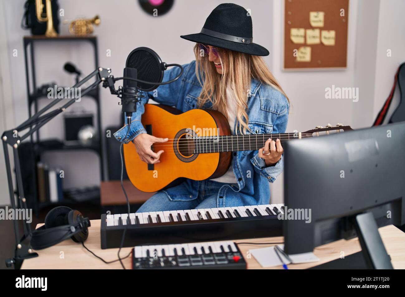 Young woman musician smiling confident playing classical guitar at ...