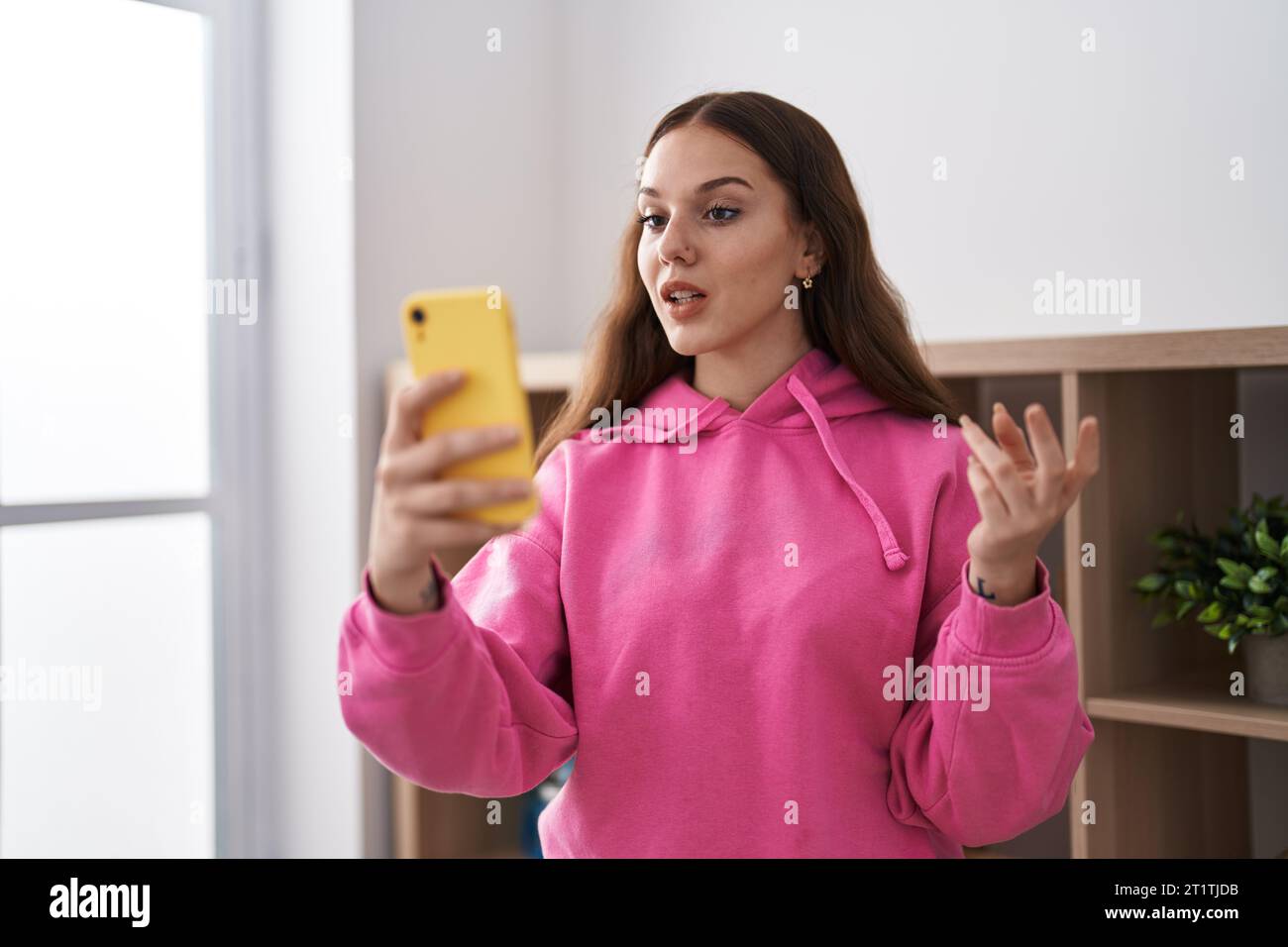 Young woman having video call at home Stock Photo - Alamy