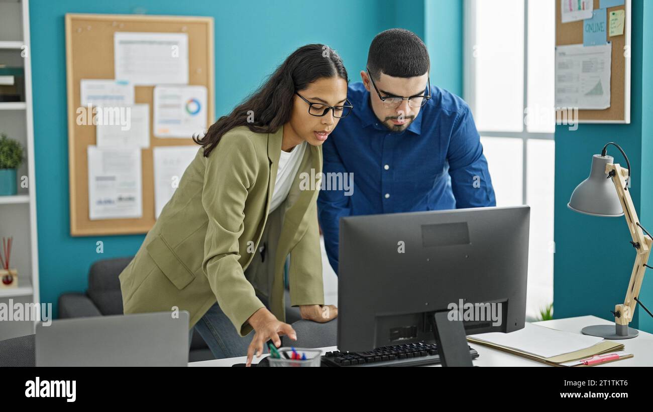 Dynamic duo at work, two professional workers, man and woman, conjuring ...