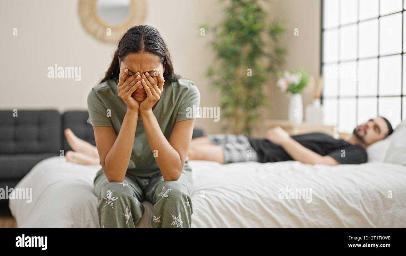 Beautiful couple expressing sadness, crying in their sleep together in ...