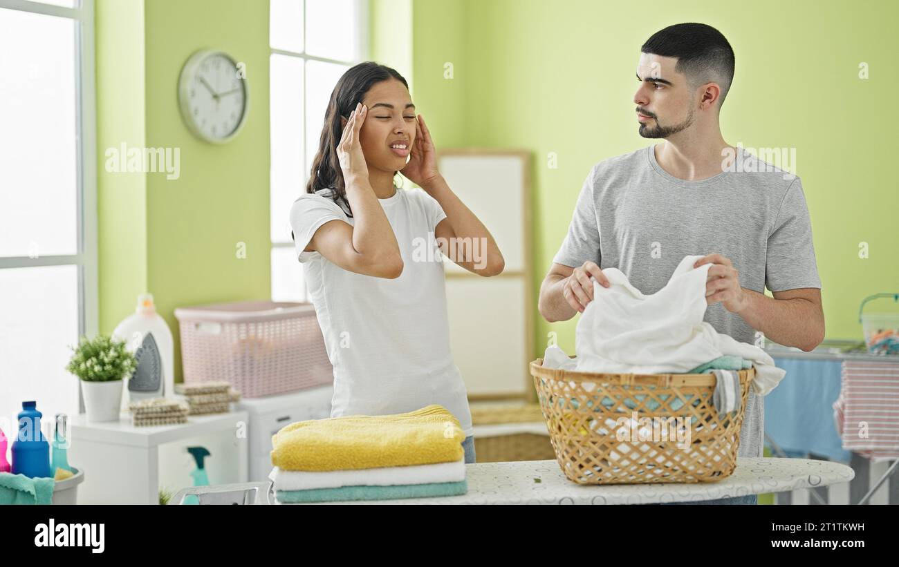 Exhausted love-struck couple suffering headache while tackling tedious ...