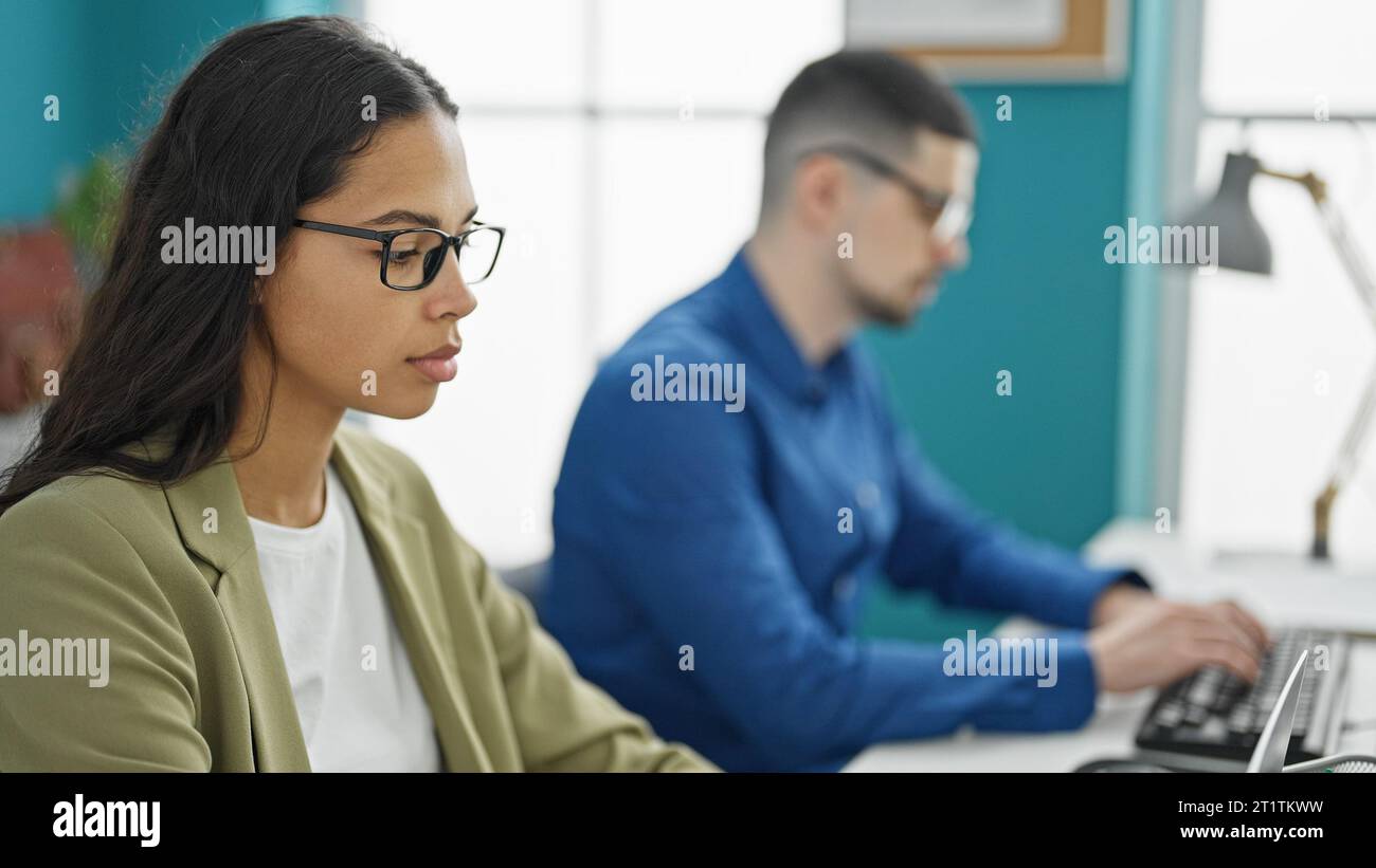 Two professional workers, man and woman, laser-focused on success ...
