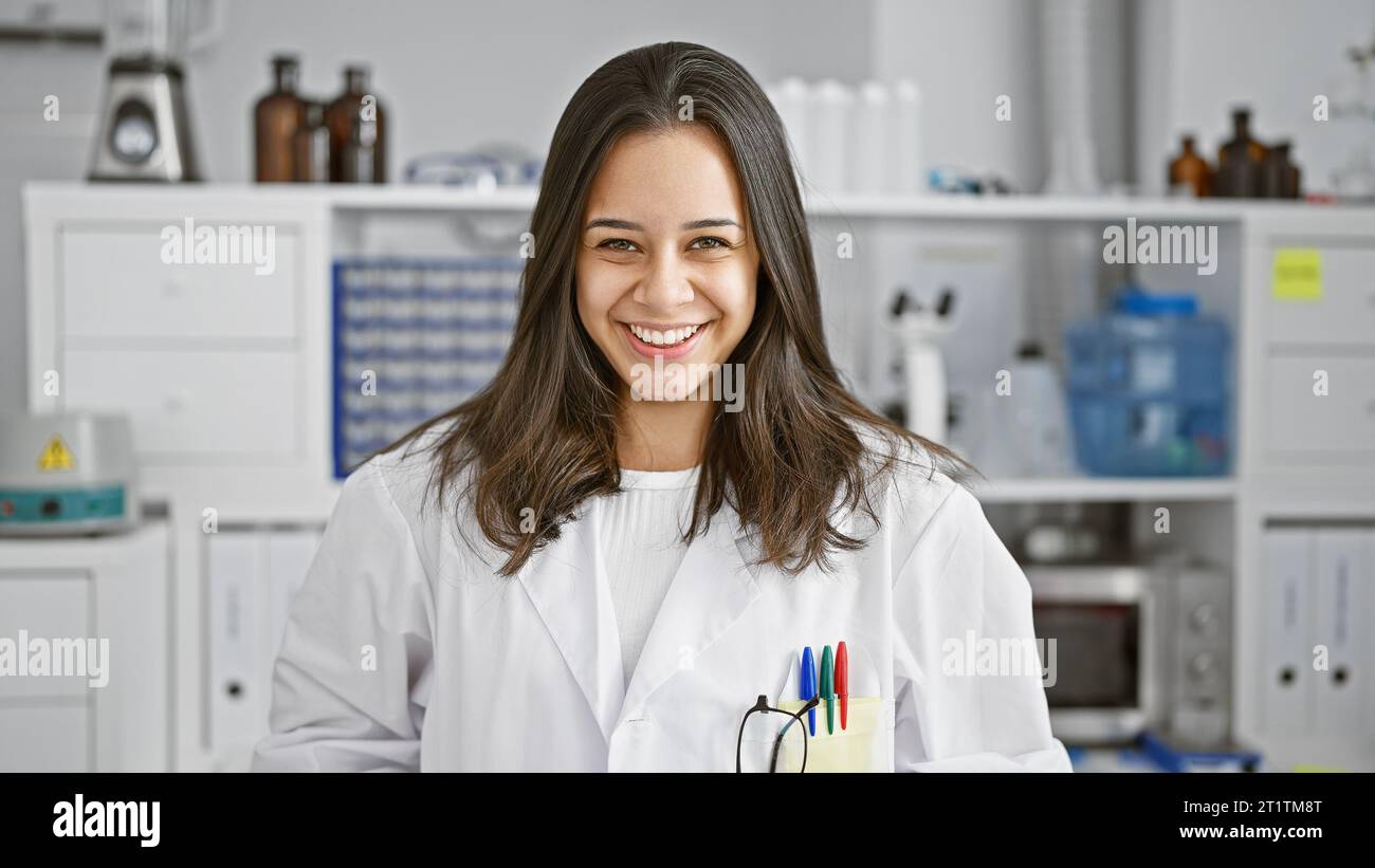 Smiling confidently, a young and beautiful hispanic woman scientist ...