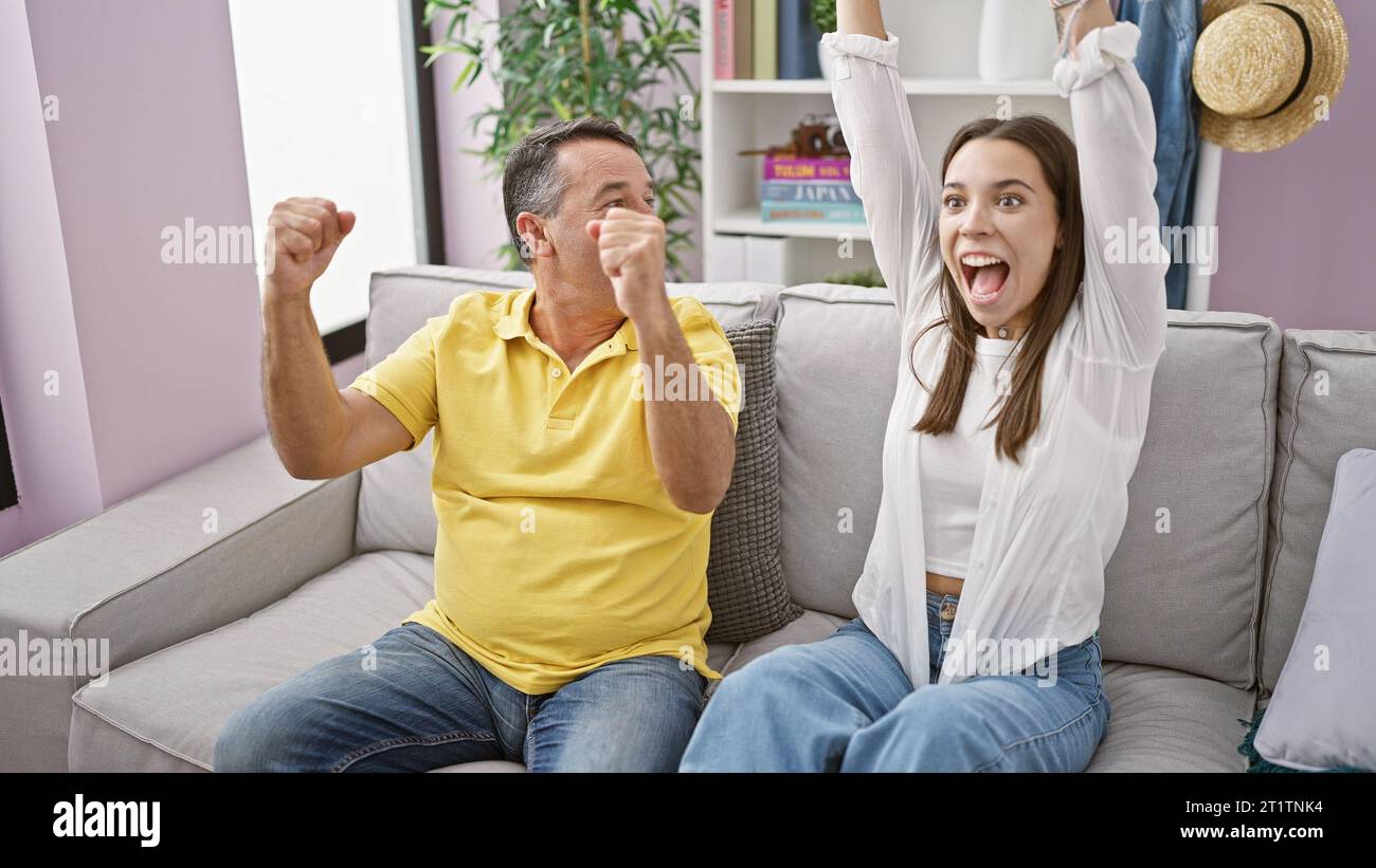 Hispanic father and daughter jubilantly celebrating a soccer match ...