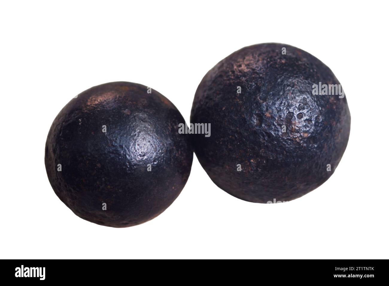 Two cannon ball one-pound closeup, isolated on white background. Old ...