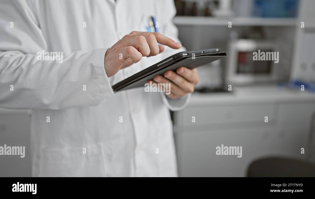 Young hispanic man scientist using touchpad at laboratory Stock Photo - Alamy
