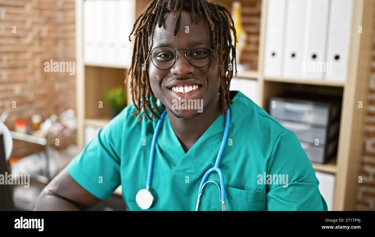 African american man doctor using computer smiling at the clinic Stock ... African american man doctor using computer smiling at the clinic Stock ...