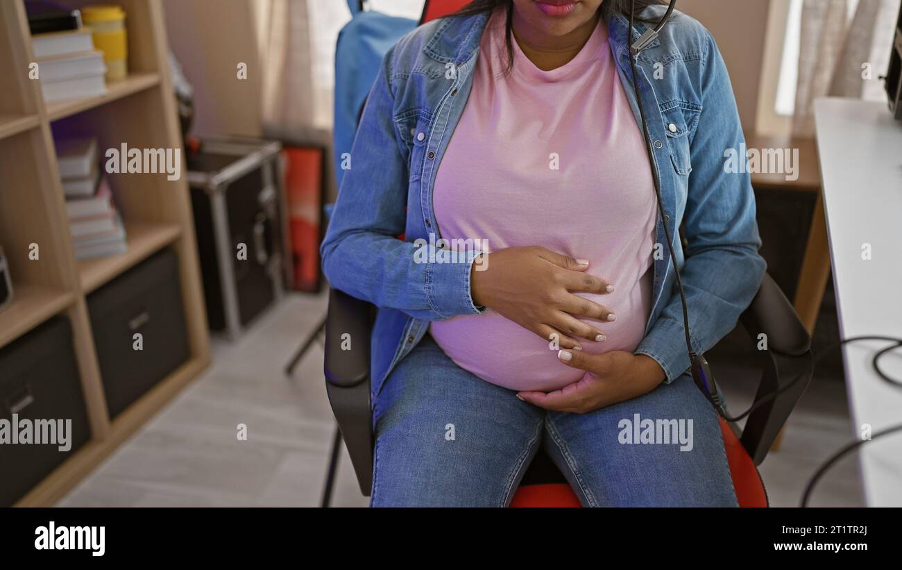 Expecting a baby! young pregnant gaming streamer touching belly ...