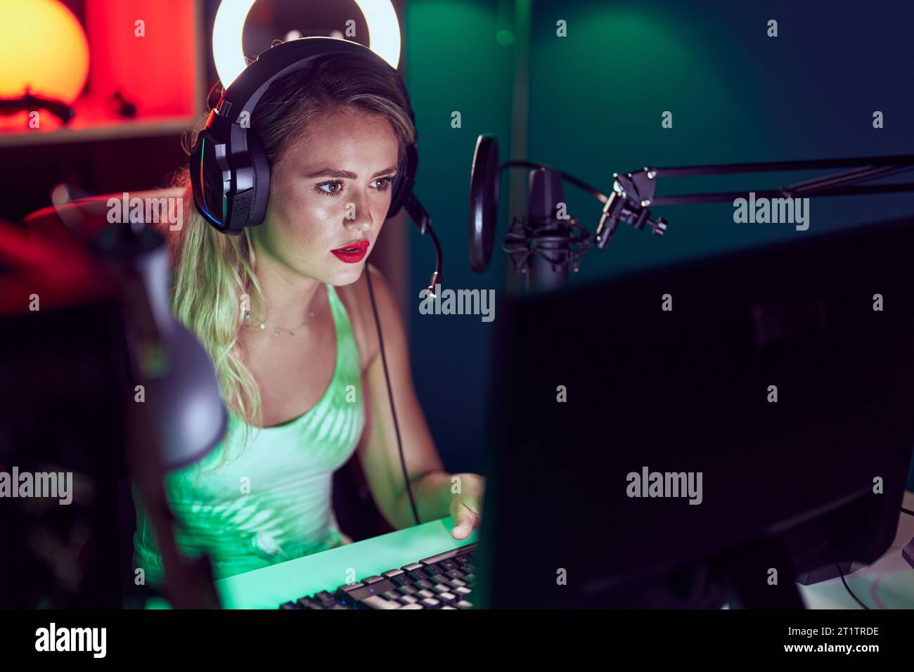 Young beautiful hispanic woman streamer playing video game using ...