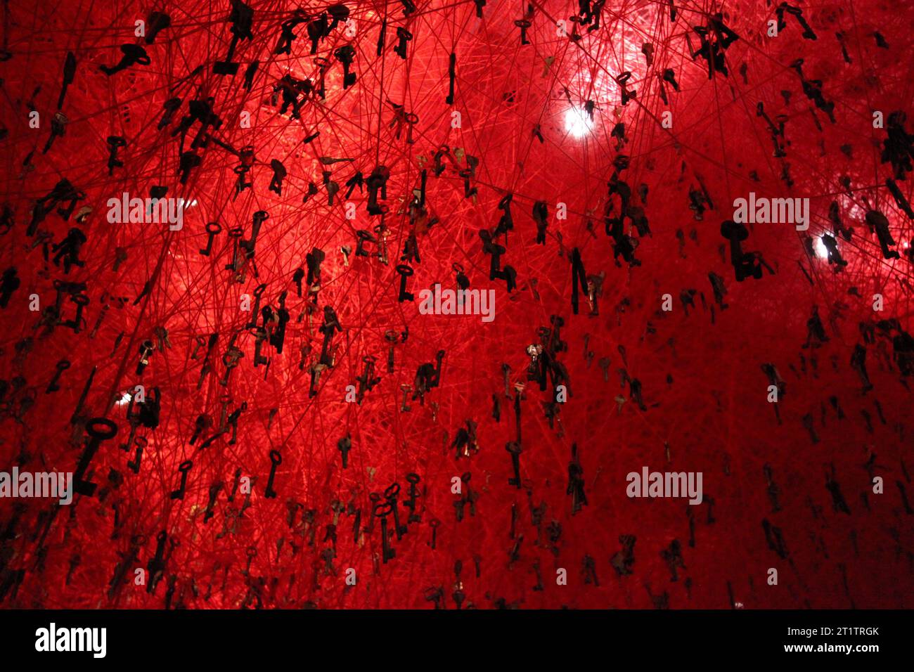 artistic installation. Some keys hanging with red threads Stock Photo ...
