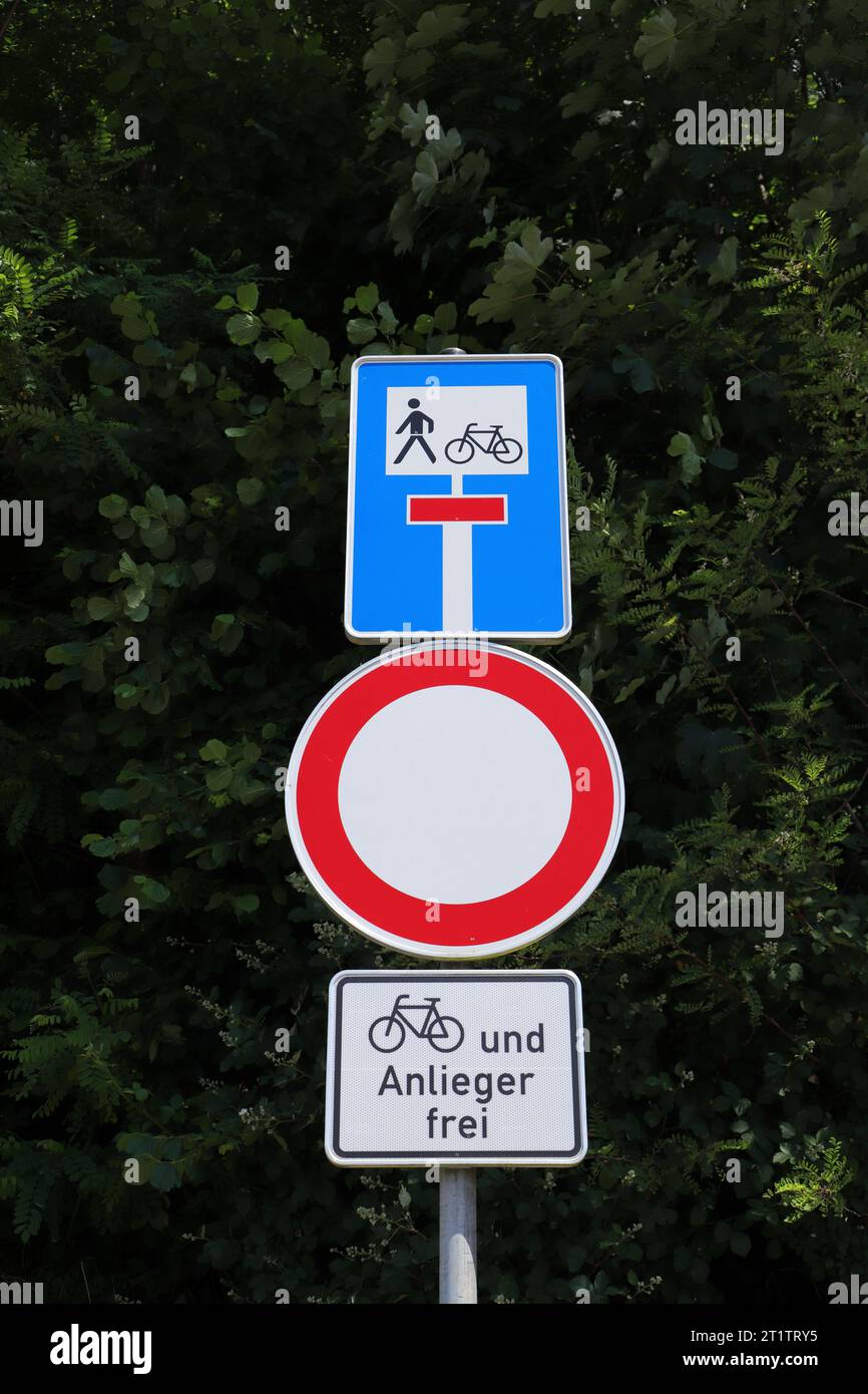 Several traffic signs prohibit passage with the inscription "Residents ...