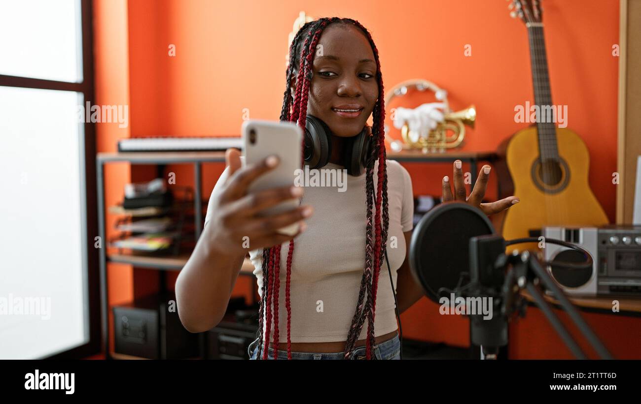 Beautiful african american woman, adult musician wearing headphones, in ...