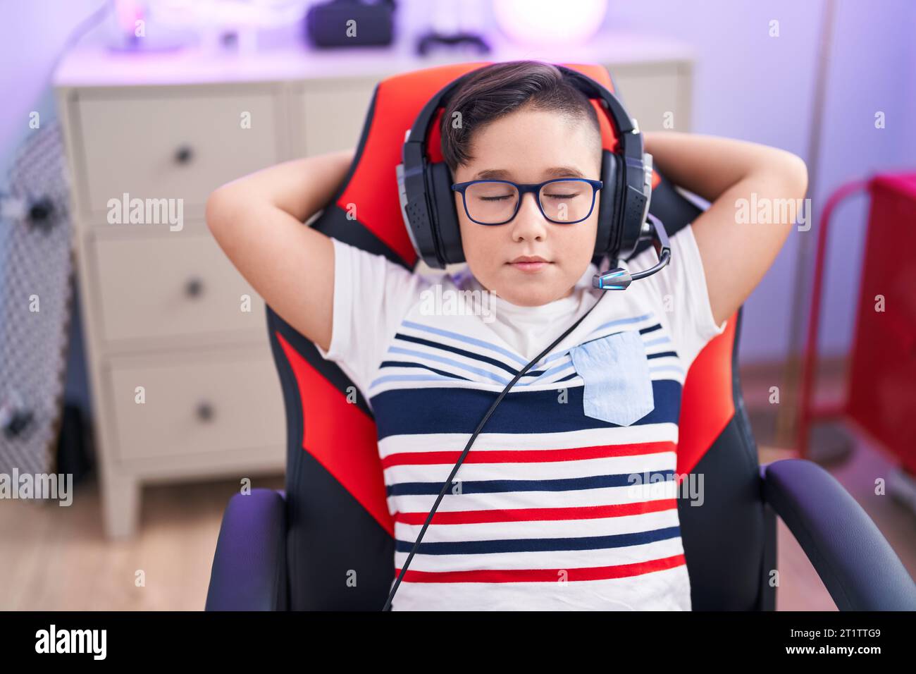 Adorable hispanic boy streamer relaxed with hands on head at gaming ...