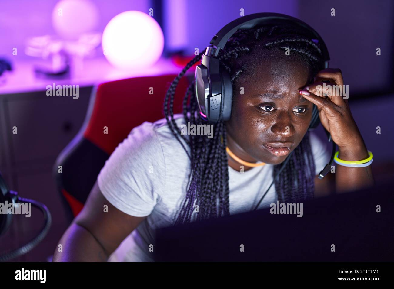 African american woman streamer stressed using computer at gaming room ...