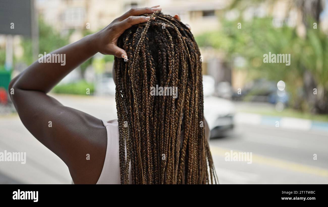 African american woman touching her hair backwards at street Stock ...