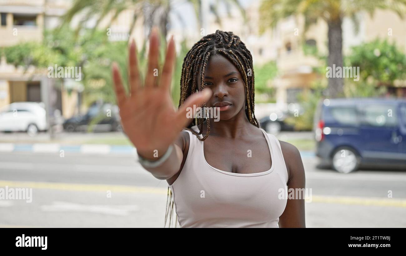African american woman doing stop gesture with hand at street Stock ...