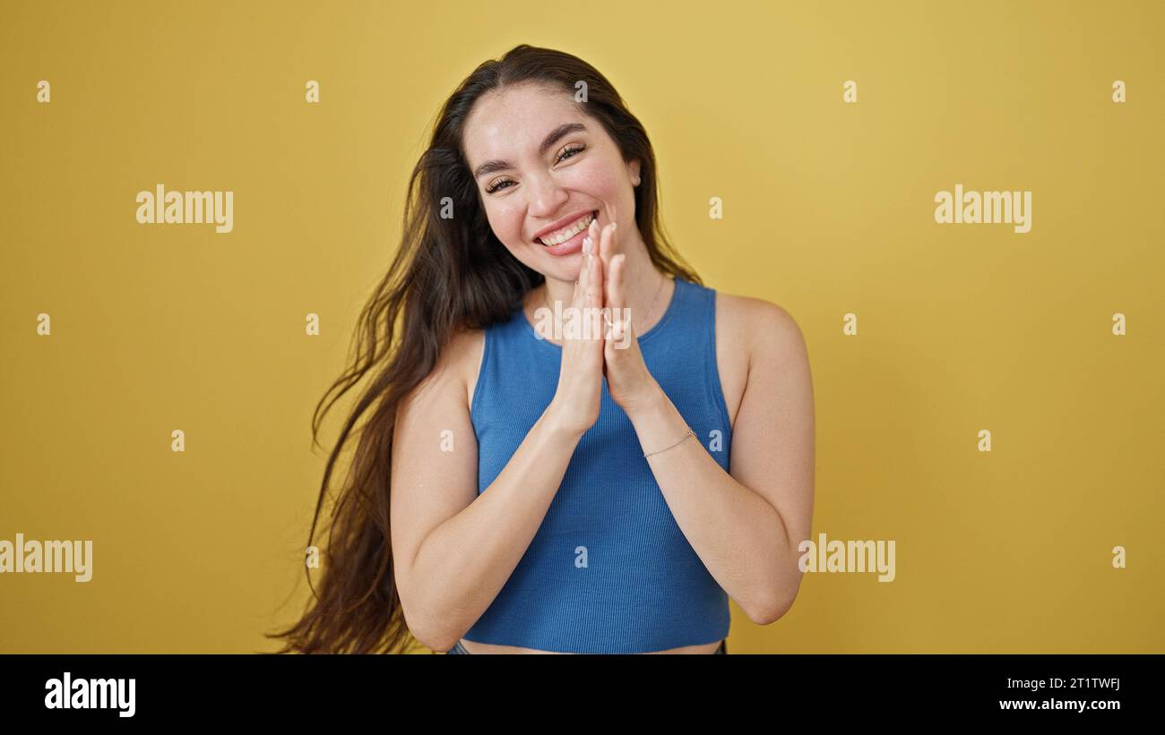 Young beautiful hispanic woman smiling confident clapping hands over ...